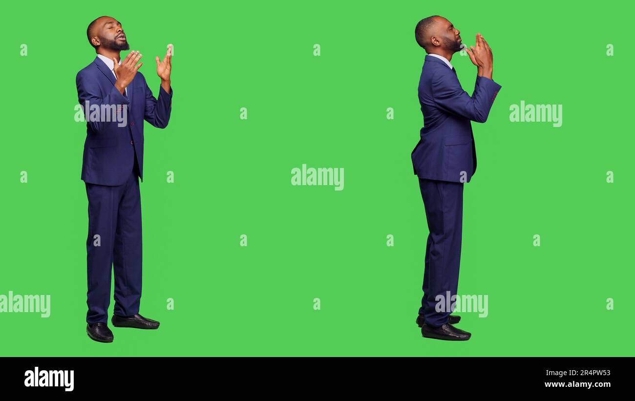 Spiritual office worker praying to god for luck on camera Stock Photo ...