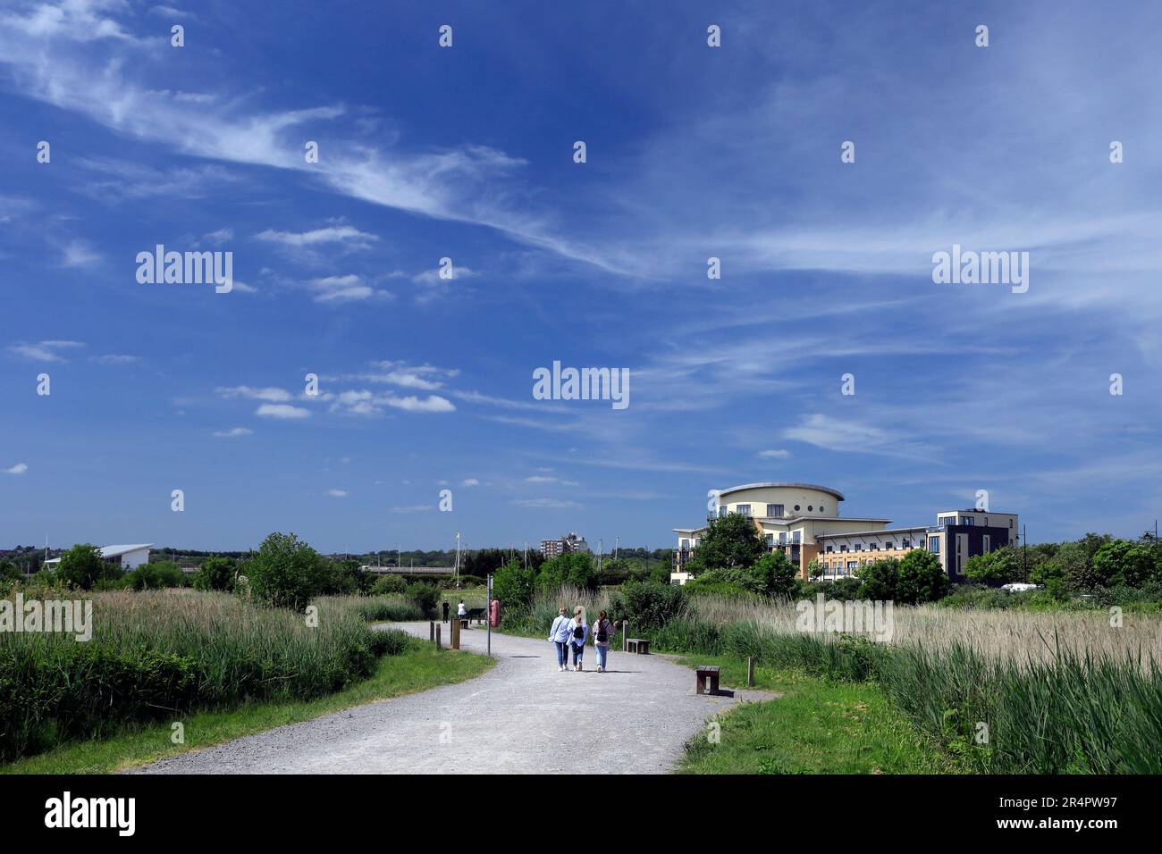 Three young women walking along a winding path, Cardiff Bay Wetland ...