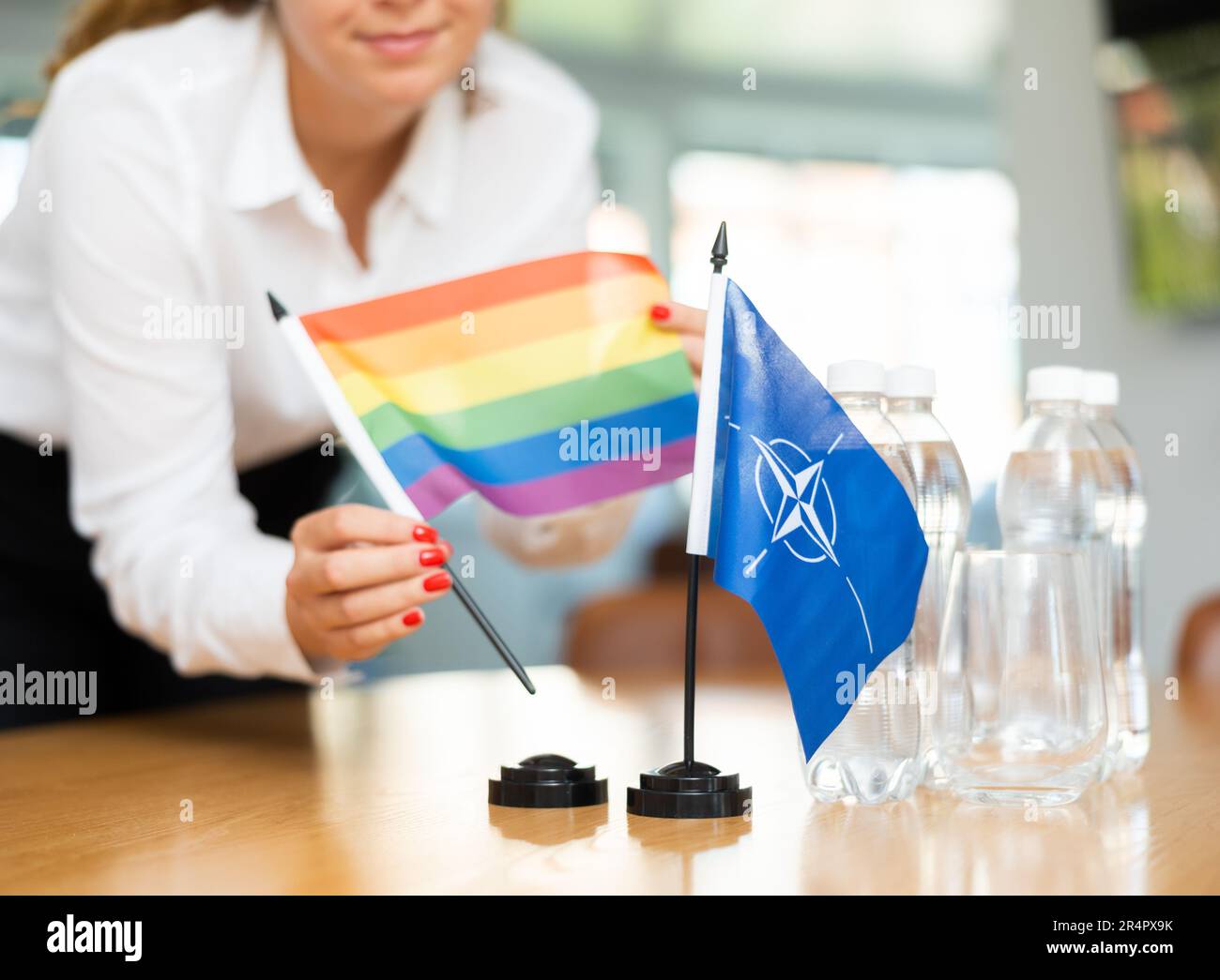 Young female secretary preparing room for international negotiations ...