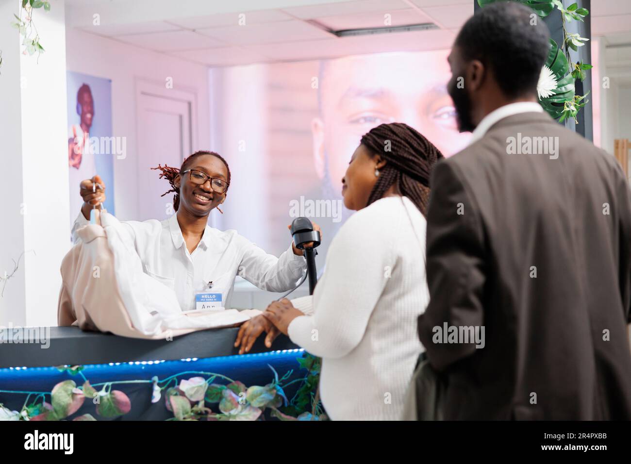 Employee using barcode scanner clothing hi-res stock photography and ...