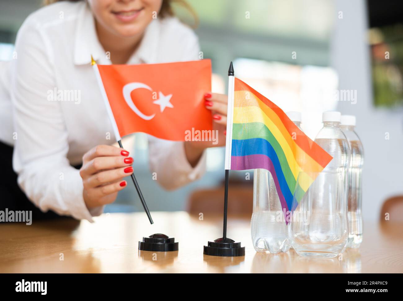 Unrecognizable girl sets midget flags of LGBT and Turkey before ...