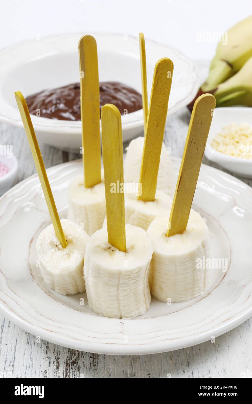 How to make chocolate dipped bananas - step by step, tutorial. Party dessert Stock Photo - Alamy