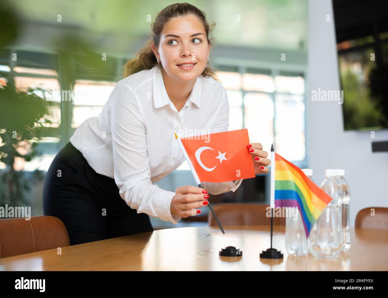 Young lady sets miniatures flags of LGBT and Turkey before ...
