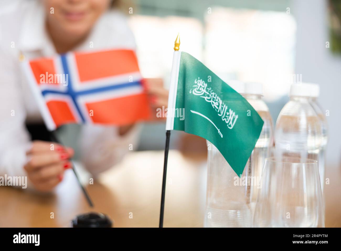 Little flag of Saudi Arabia on table and flag of Norway put next to it ...