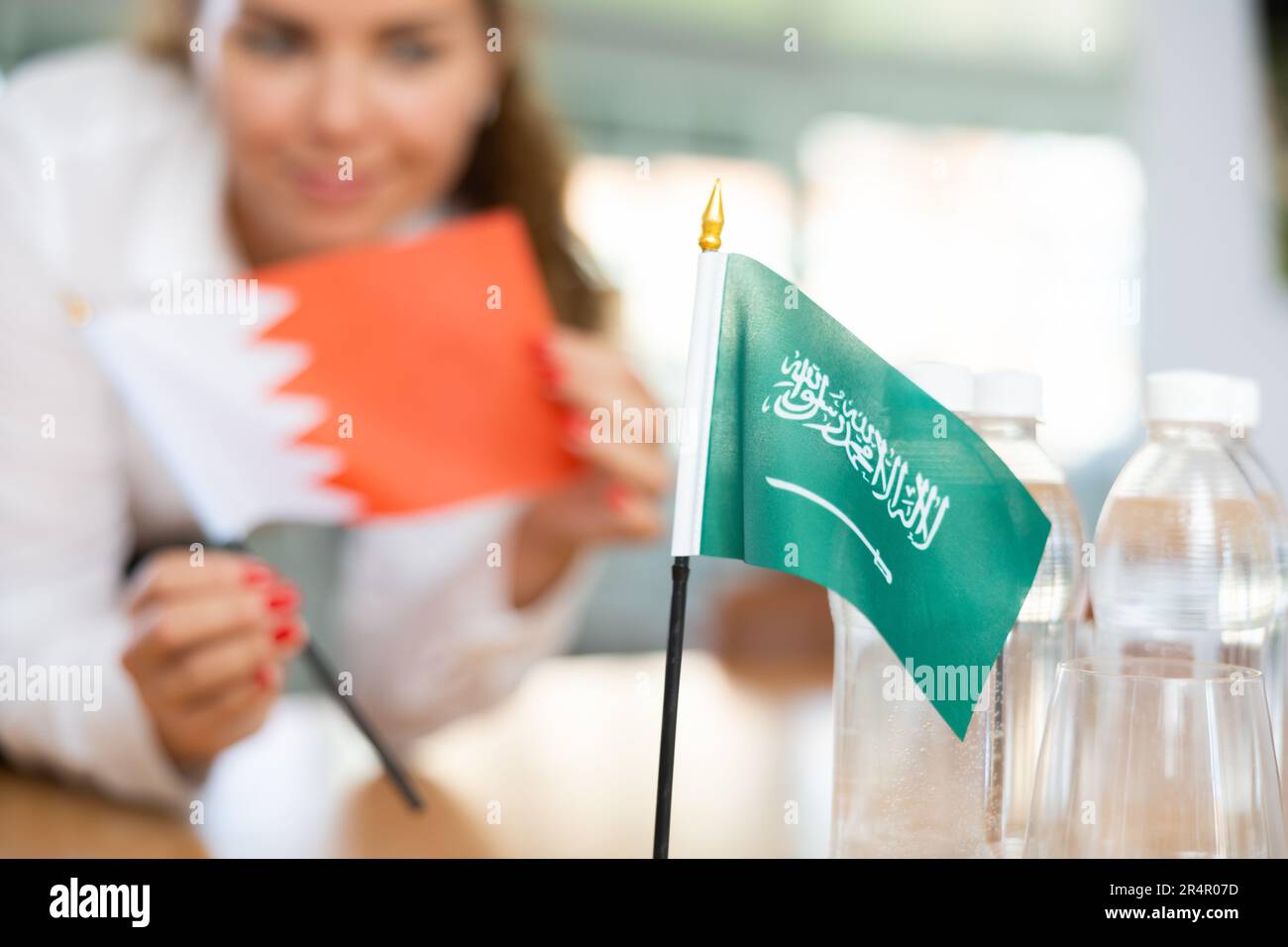 Little flag of Saudi Arabia on table and flag of Bahrain put next to it ...