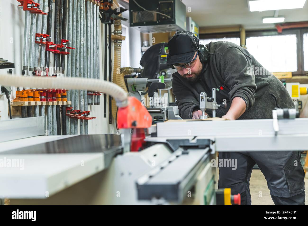 professional male carpenter working focused on his product, woodworking ...