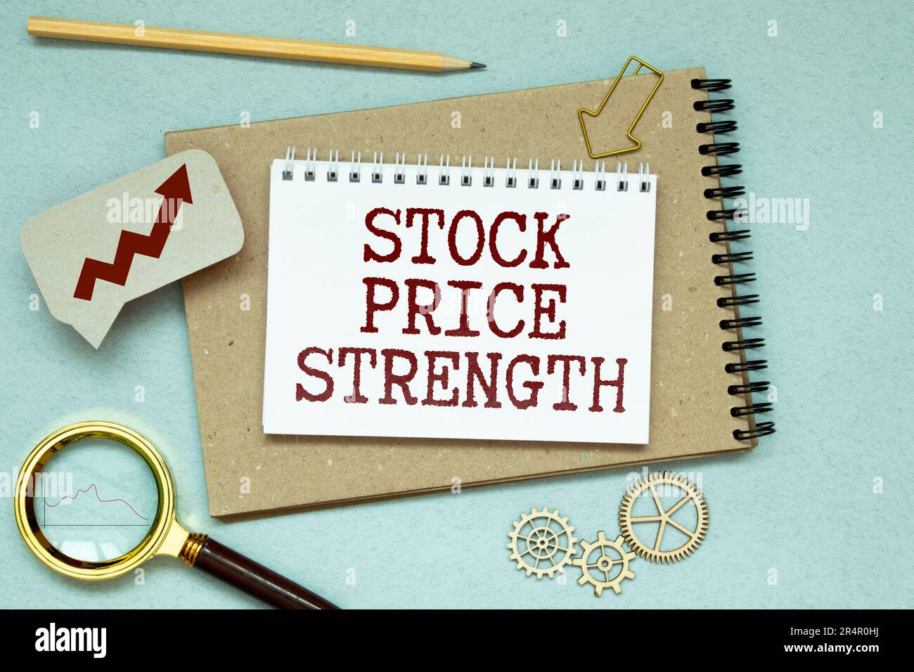 Business concept. On the financial charts lies a pen and a sign with the inscription - STOCK ...