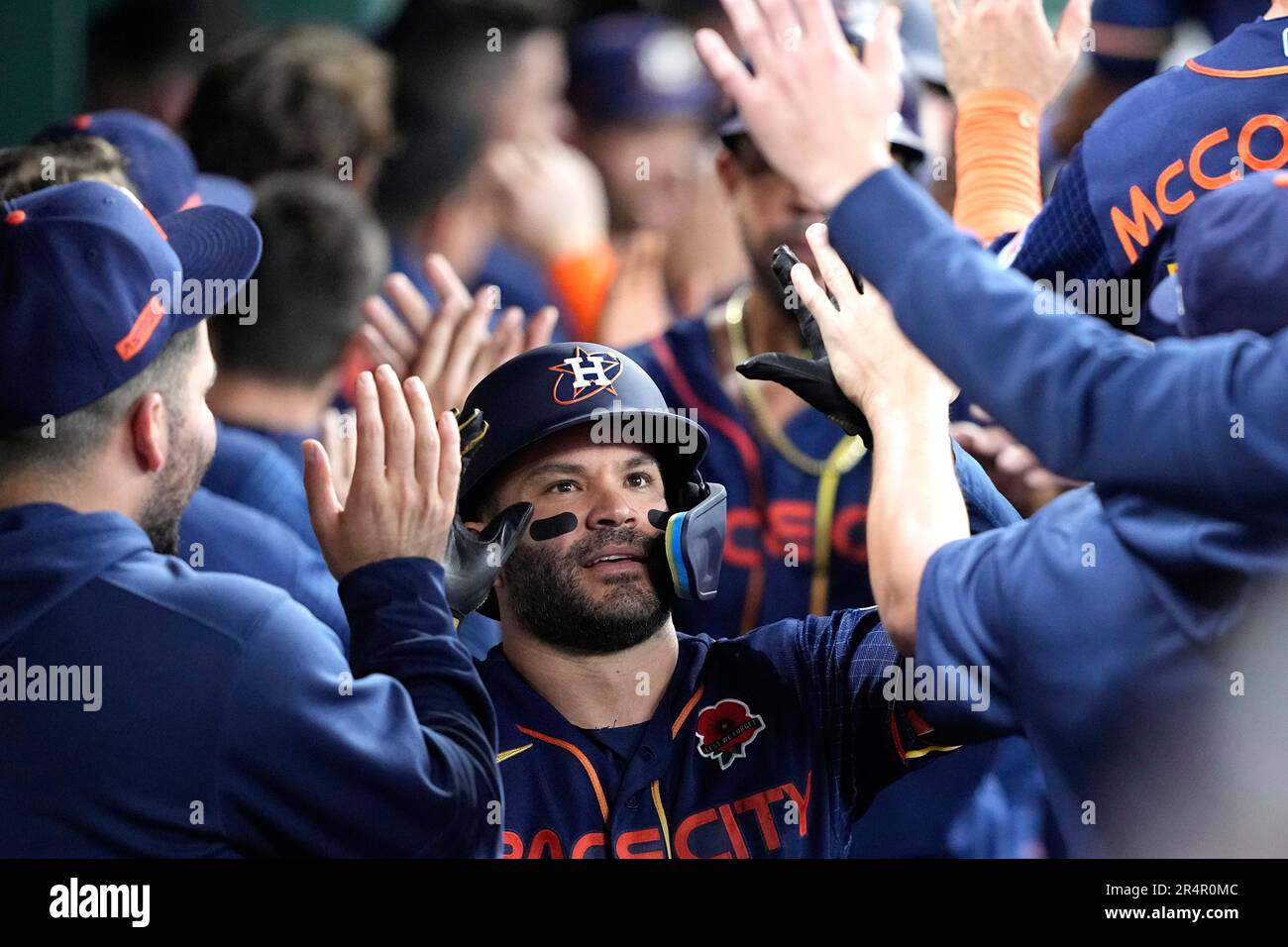 Houston Astros' Jose Altuve celebrates in the dugout after hitting a ...