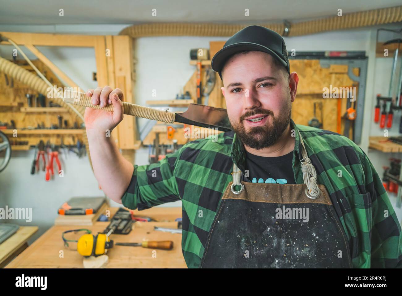 Portrait of a carpenter posing with a Japanese saw traditional ...