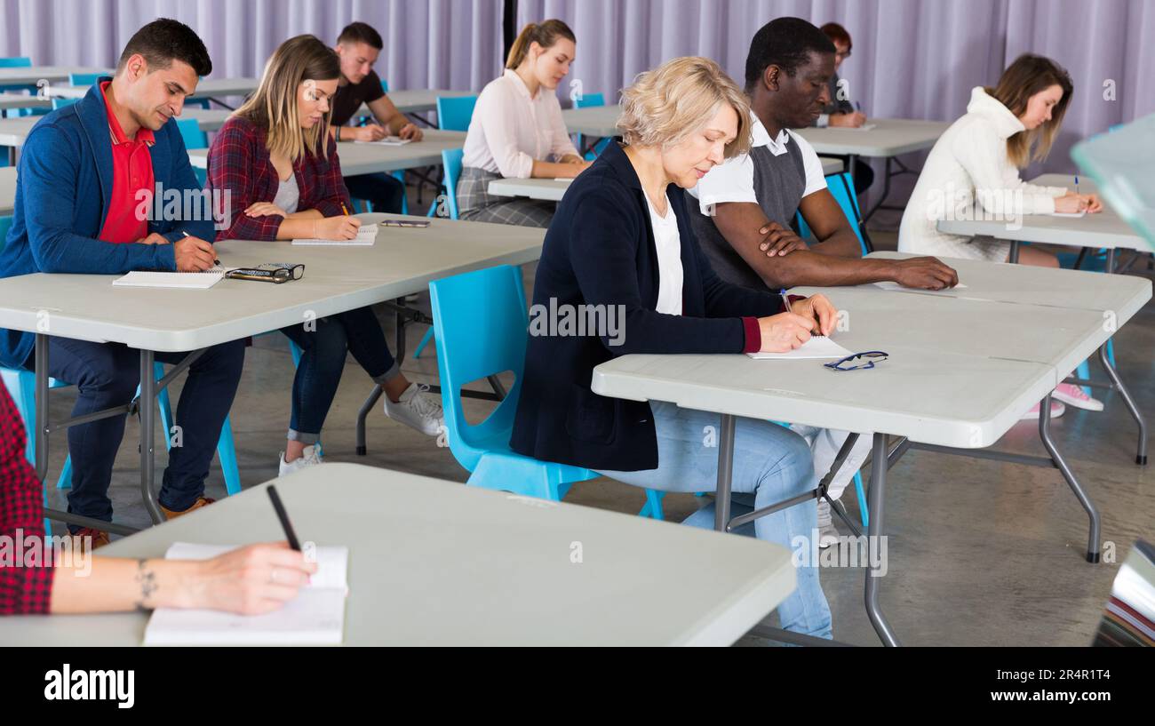 Adult students listening in classroom Stock Photo - Alamy