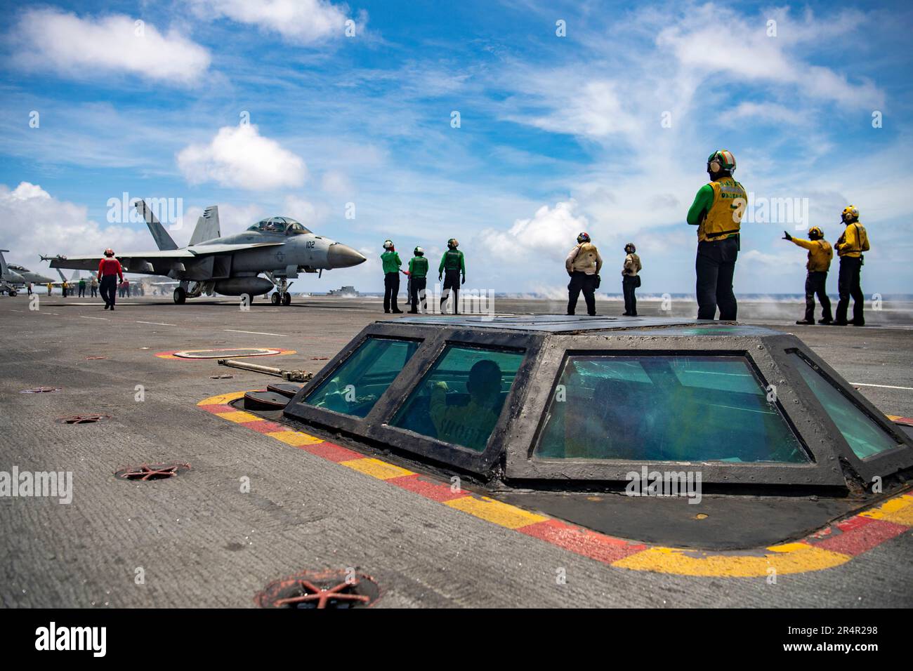 230528-N-DU622-1018 PACIFIC OCEAN (May 28, 2023) U.S. Navy Sailors guide an F/A-18F Super Hornet ...