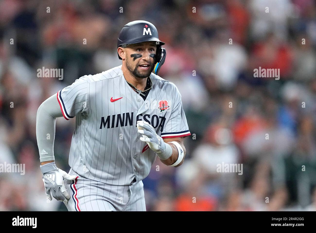 Minnesota Twins' Royce Lewis runs up the first base line after hitting ...