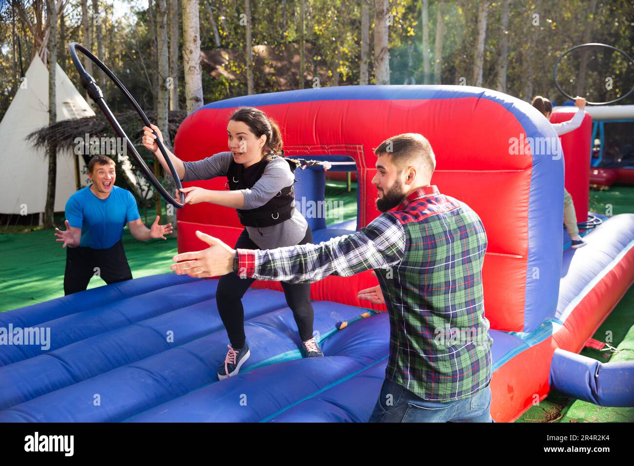 Woman playing tug of war with hoop Stock Photo - Alamy