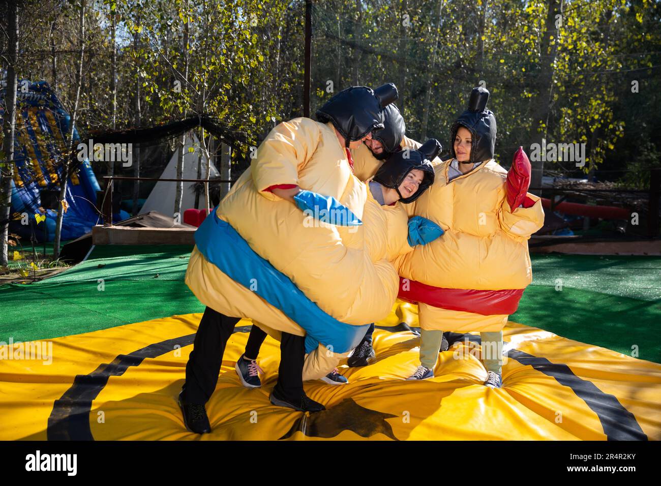 Friends posing in inflatable sumo suits Stock Photo - Alamy