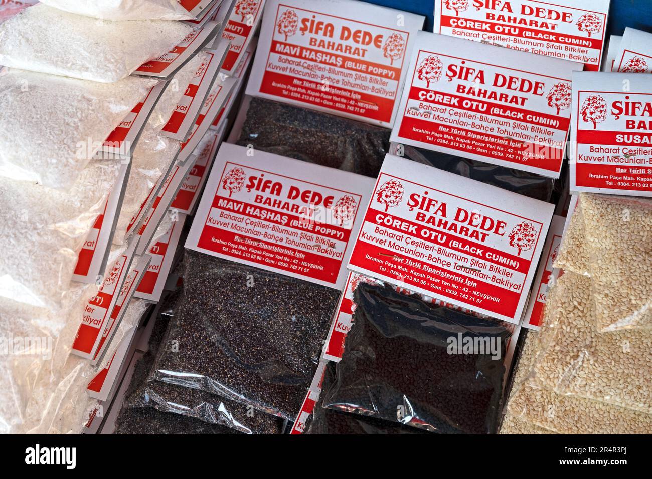 Packets of blue poppy seeds and black cumin for sale at the weekly ...