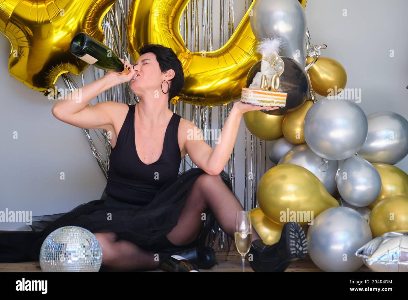 Caucasian woman drinking champagne from bottle celebrating her 40 ...