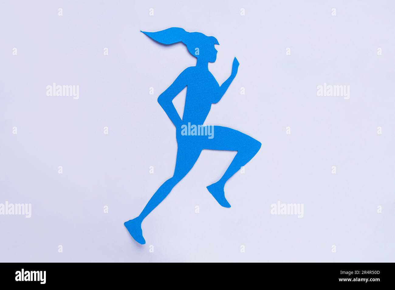 Woman`s health. Paper female figure running on white background, top ...