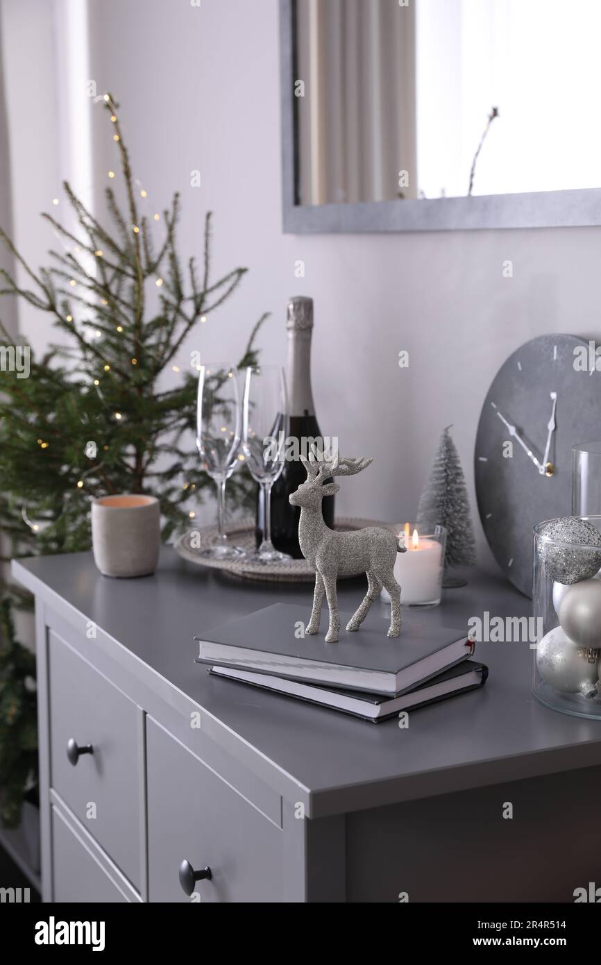 Christmas tree and decor on chest of drawers indoors. Interior design ...