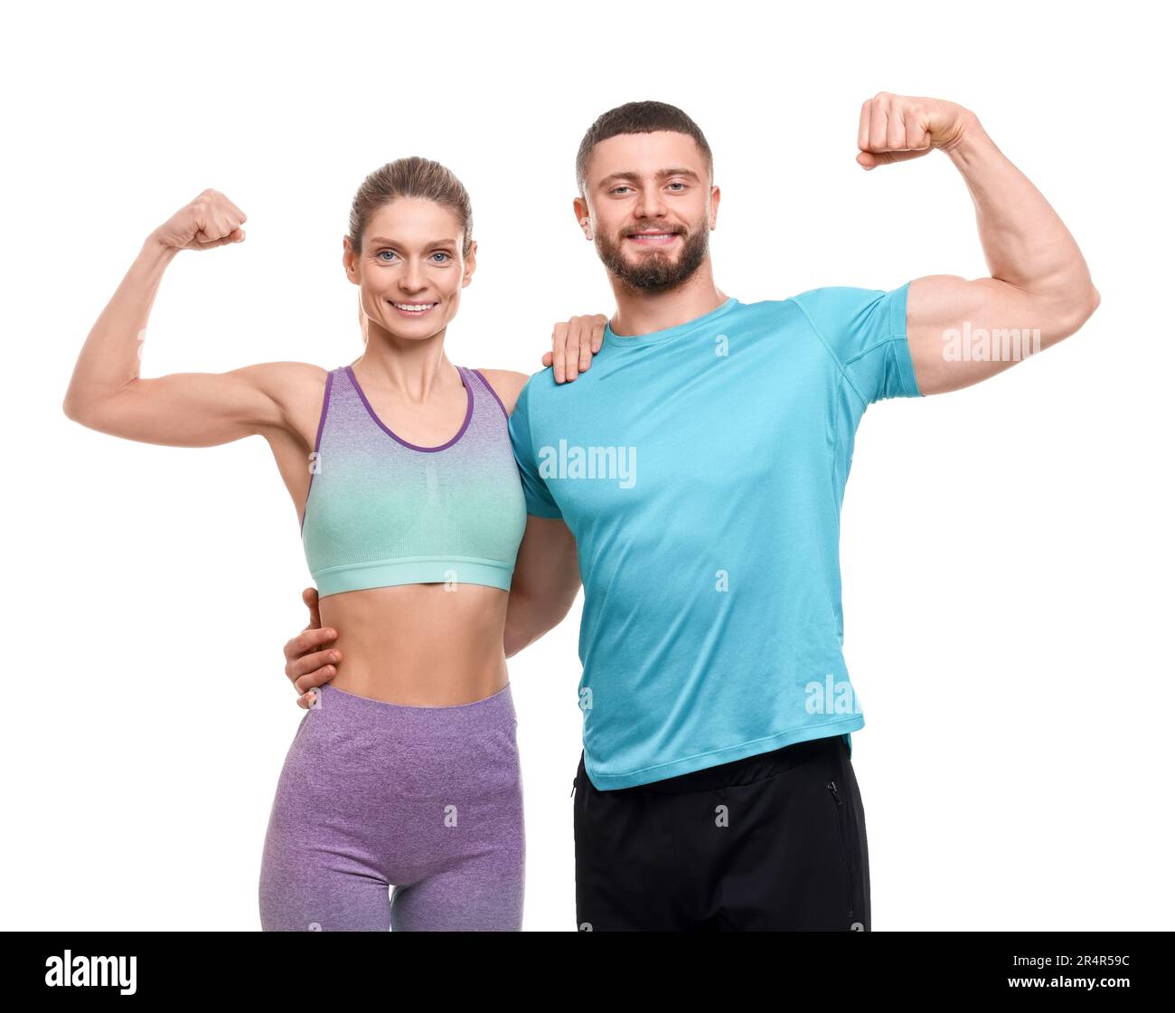 Athletic people showing muscles on white background Stock Photo - Alamy
