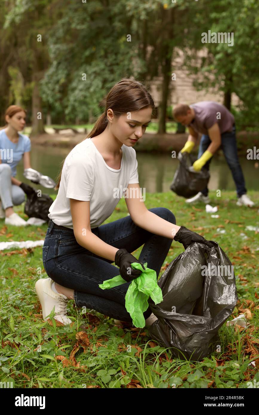 Woman volunteer holding plastic bag hi-res stock photography and images ...
