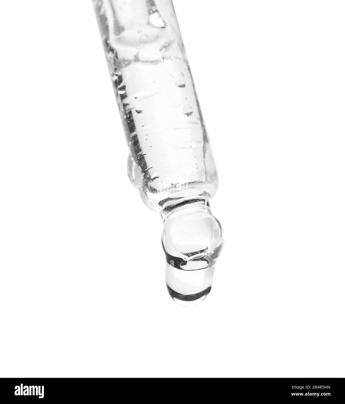 Dripping face serum from pipette on white background, closeup. Space ...