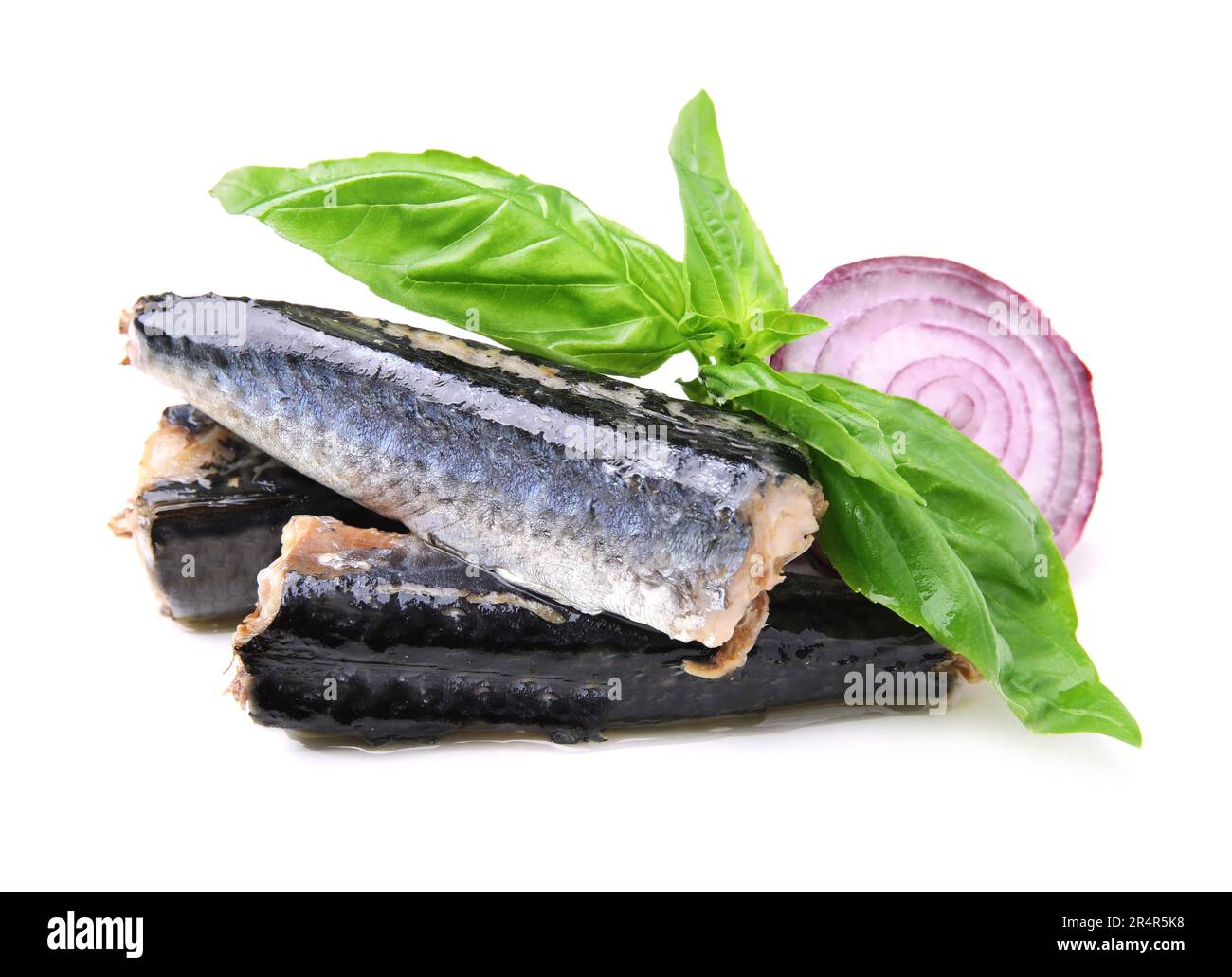 Canned mackerel fillets with red onion rings and basil on white ...