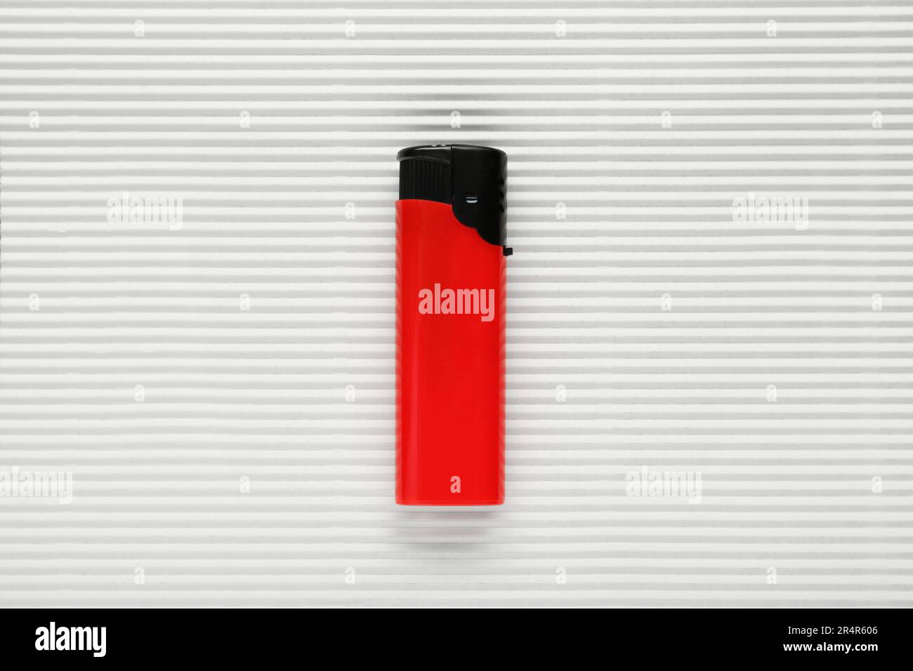 Stylish small pocket lighter on white corrugated fiberboard, top view ...