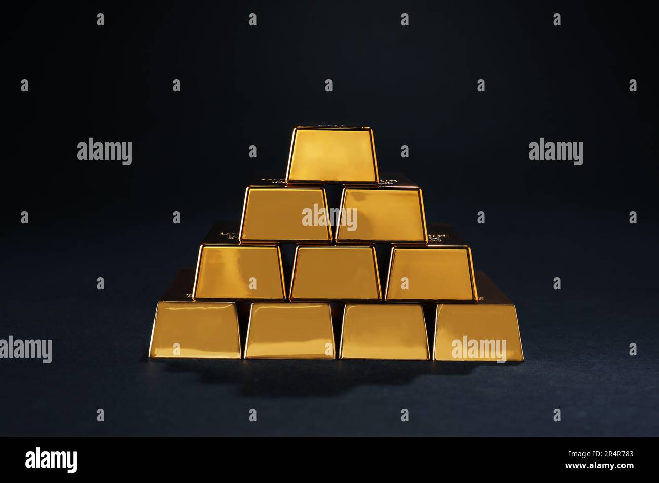 Stack of shiny gold bars on black background Stock Photo - Alamy