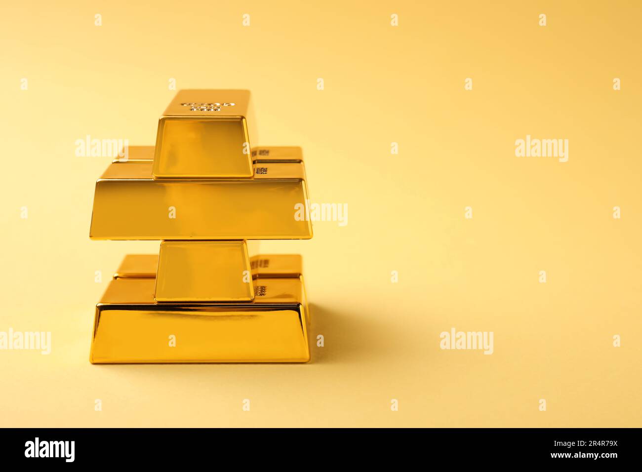 Stack of shiny gold bars on yellow background. Space for text Stock Photo - Alamy