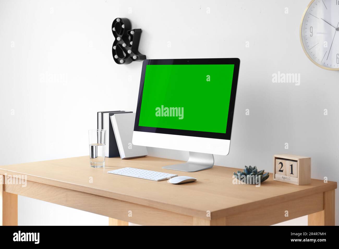 Computer display with chroma key on desk in room. Comfortable workplace ...