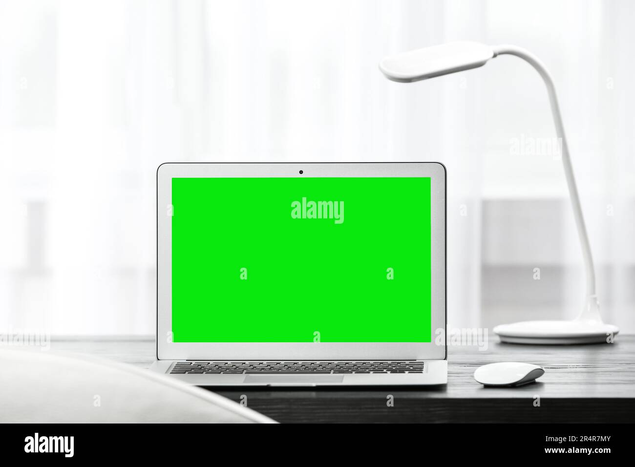 Laptop display with chroma key on desk in room. Comfortable workplace ...