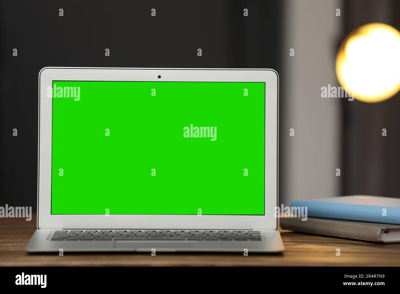 Laptop display with chroma key on desk in room. Comfortable workplace ...