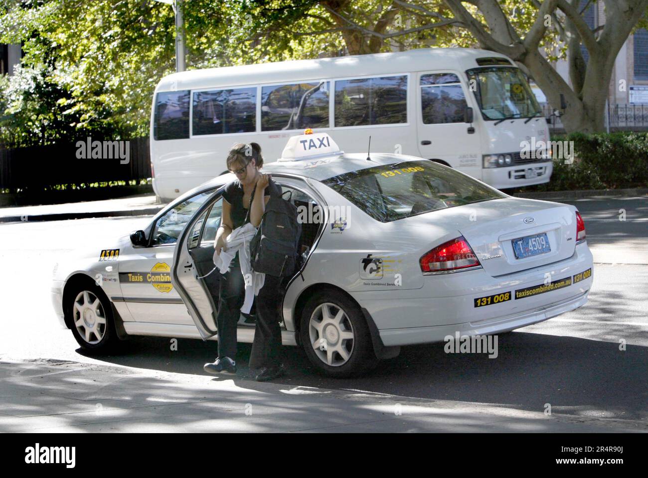 A passenger emerges from a contemporary taxi cab on Saint James Road at ...