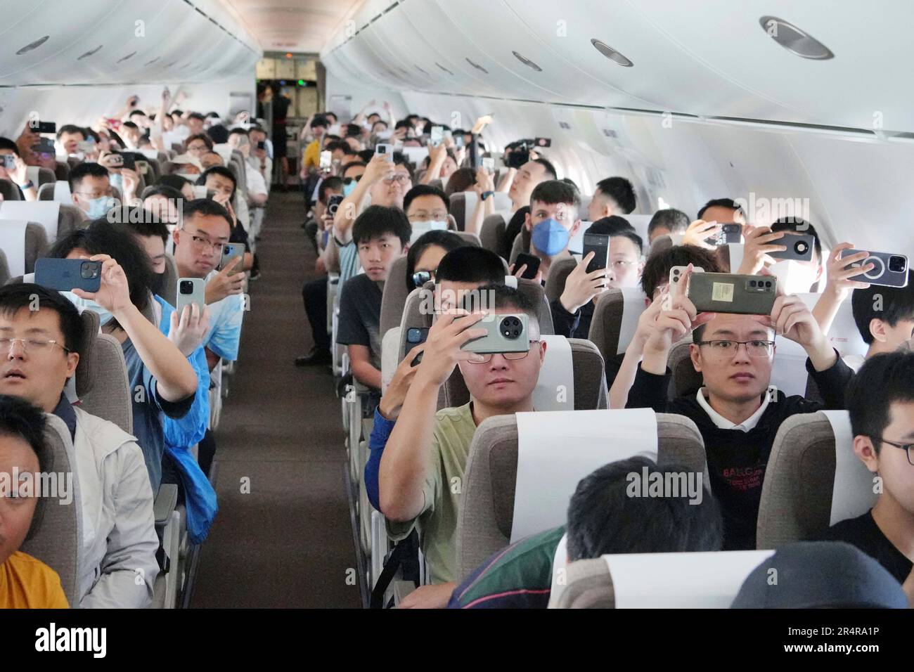 Passengers on C919 aircraft of China Eastern Airline's first regular flight are pictured on May ...