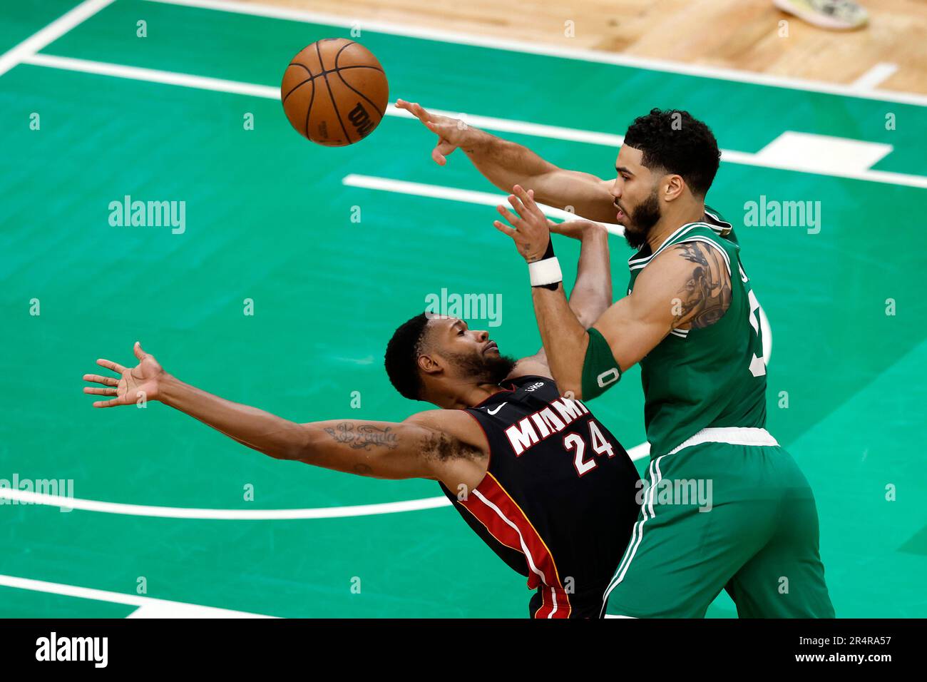 Boston Celtics forward Jayson Tatum, right, passes as he collides with ...
