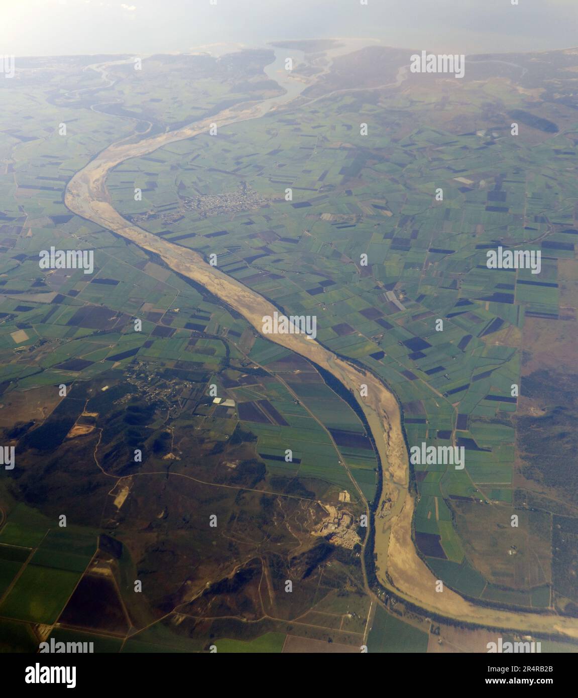 Aerial view of the Burdekin River mouth showing sugar cane farms ...