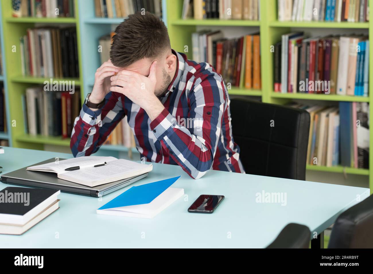 Stressed Student in High School Sitting at the Library Desk Stock Photo ...