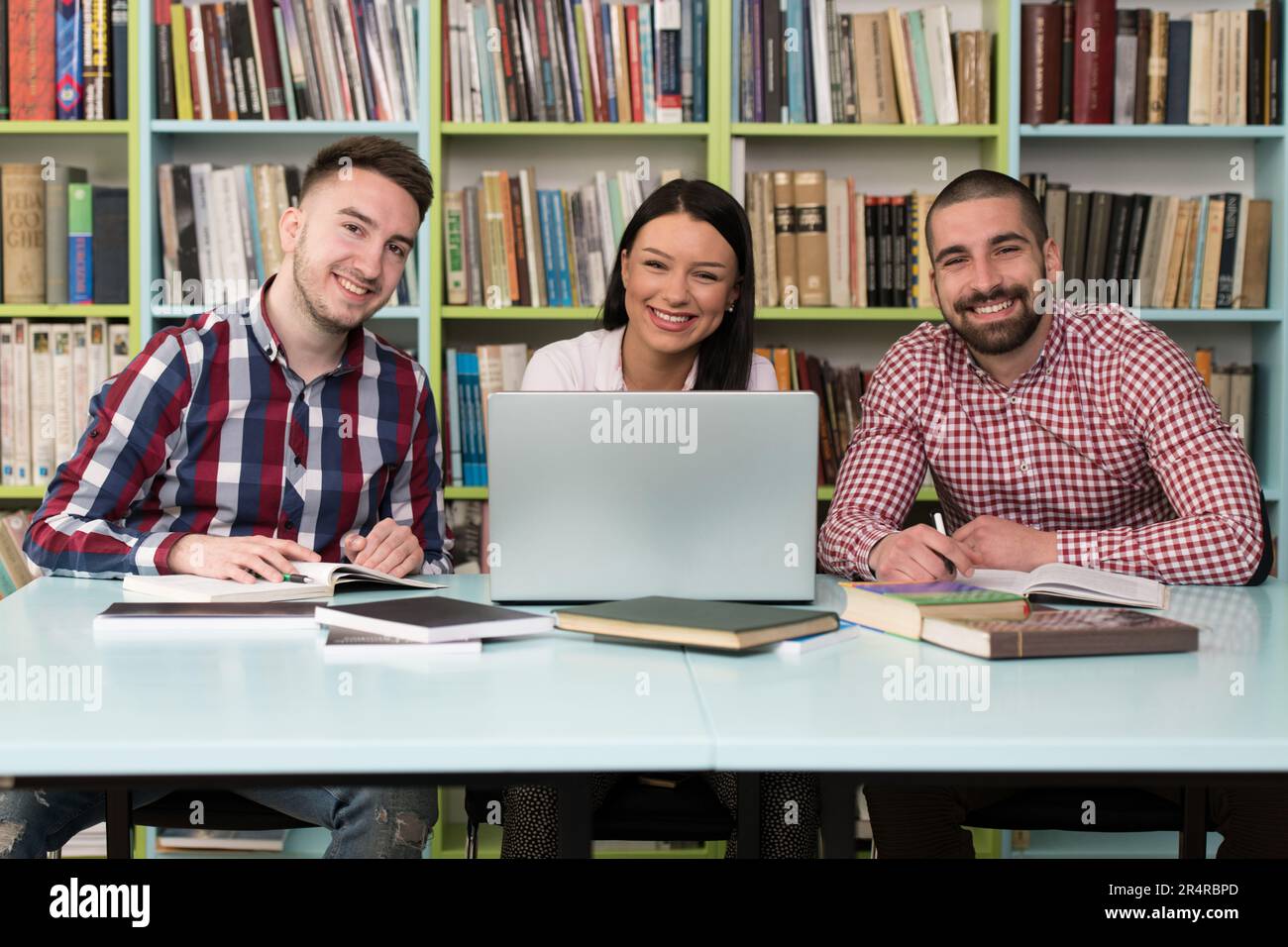 Portrait Of Clever Students With Open Book Reading It In College ...