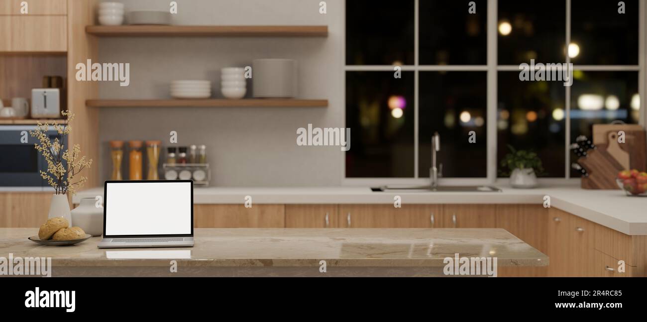A laptop computer white screen mockup on a marble kitchen island or ...