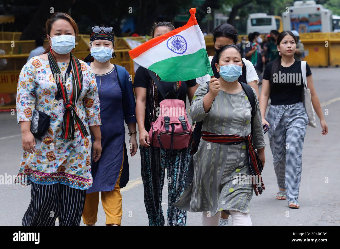 A woman belonging to Manipur 'Kuki tribe' holds an Indian flag while ...