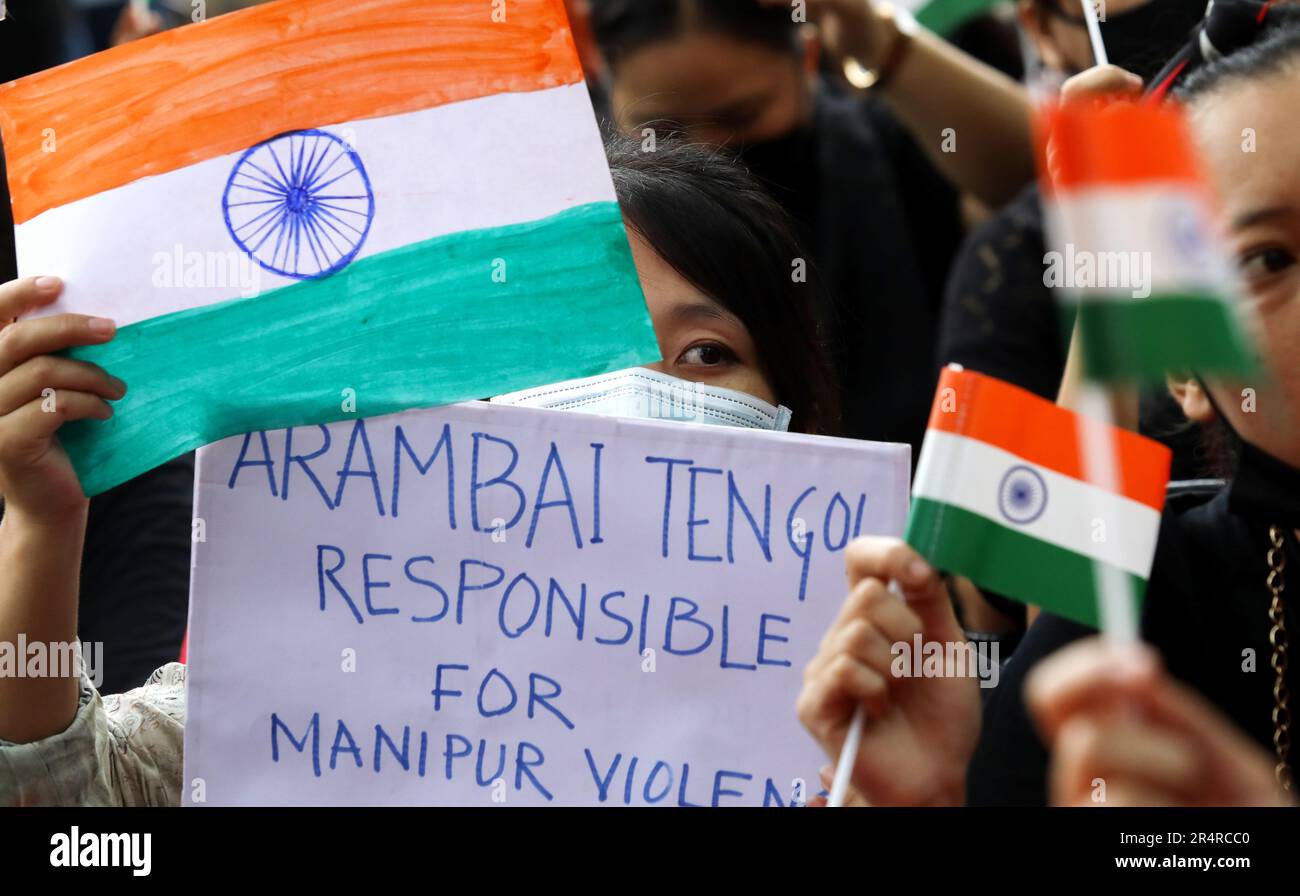 People belonging to Manipur 'Kuki tribe' hold Indian flags and placard ...