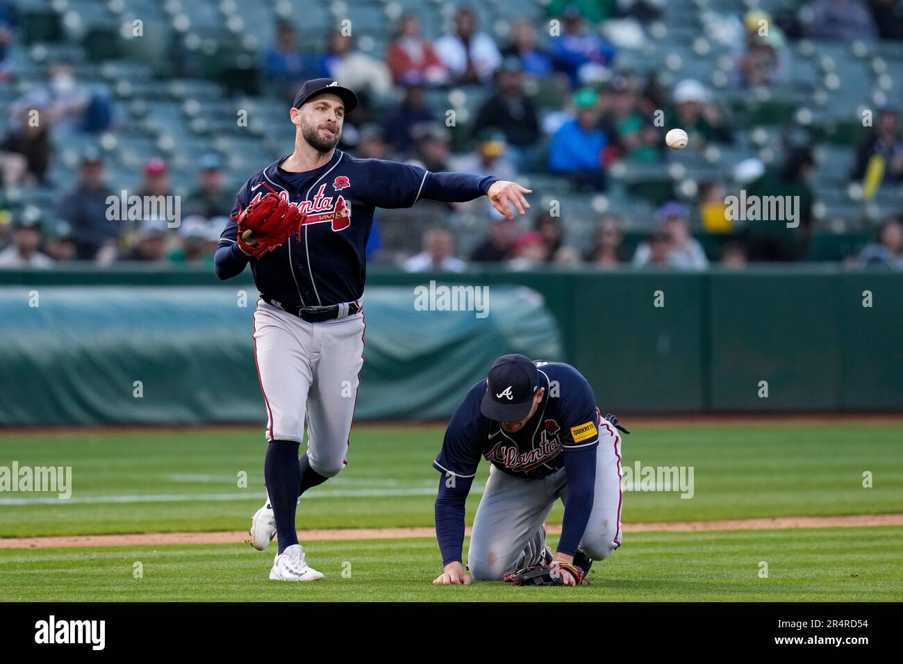 Atlanta Braves pitcher Lucas Luetge, left, throws to first on an RBI ...