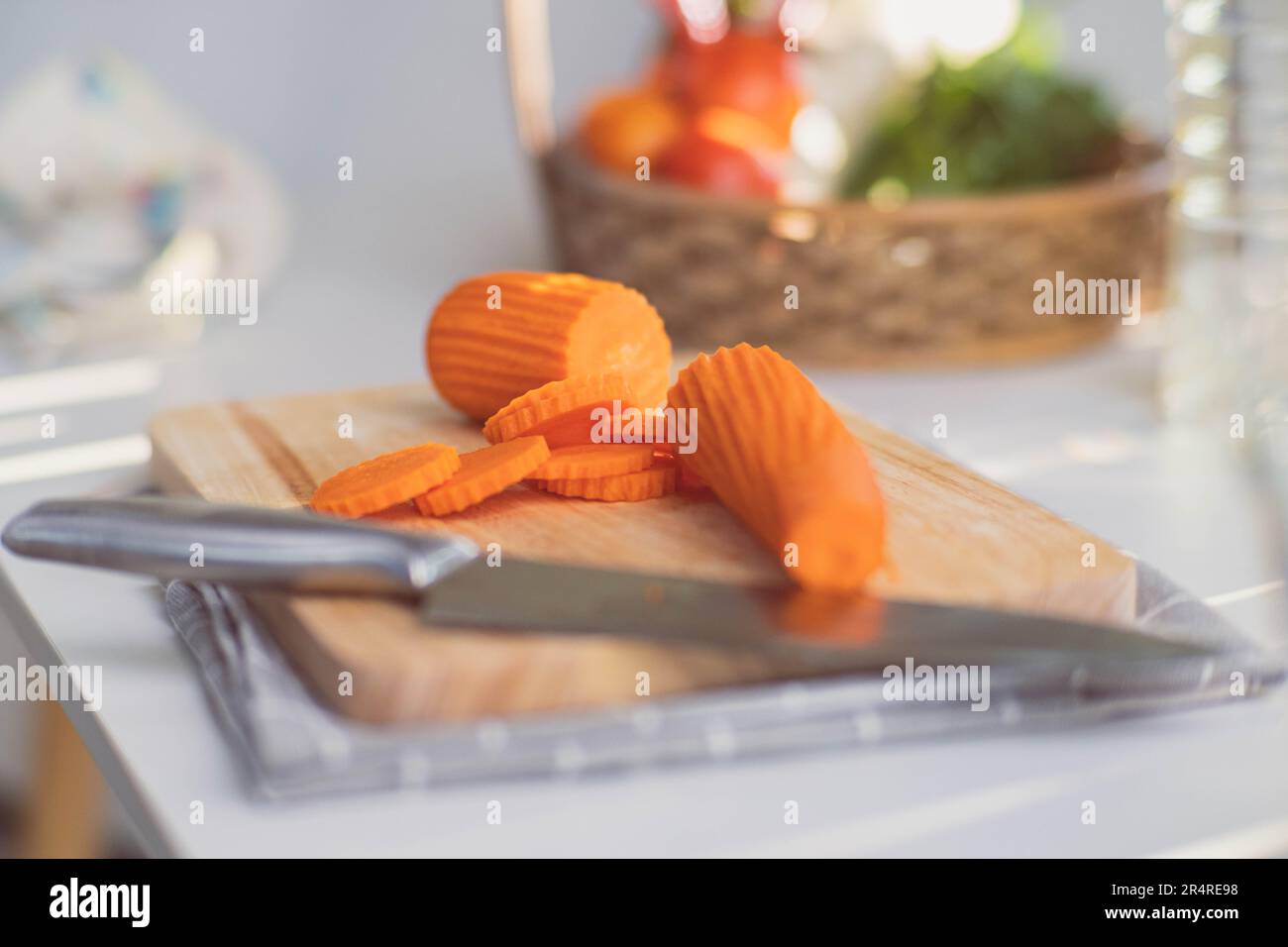 Cooking - Chef's hands are chopping carrots on the chopping board in ...
