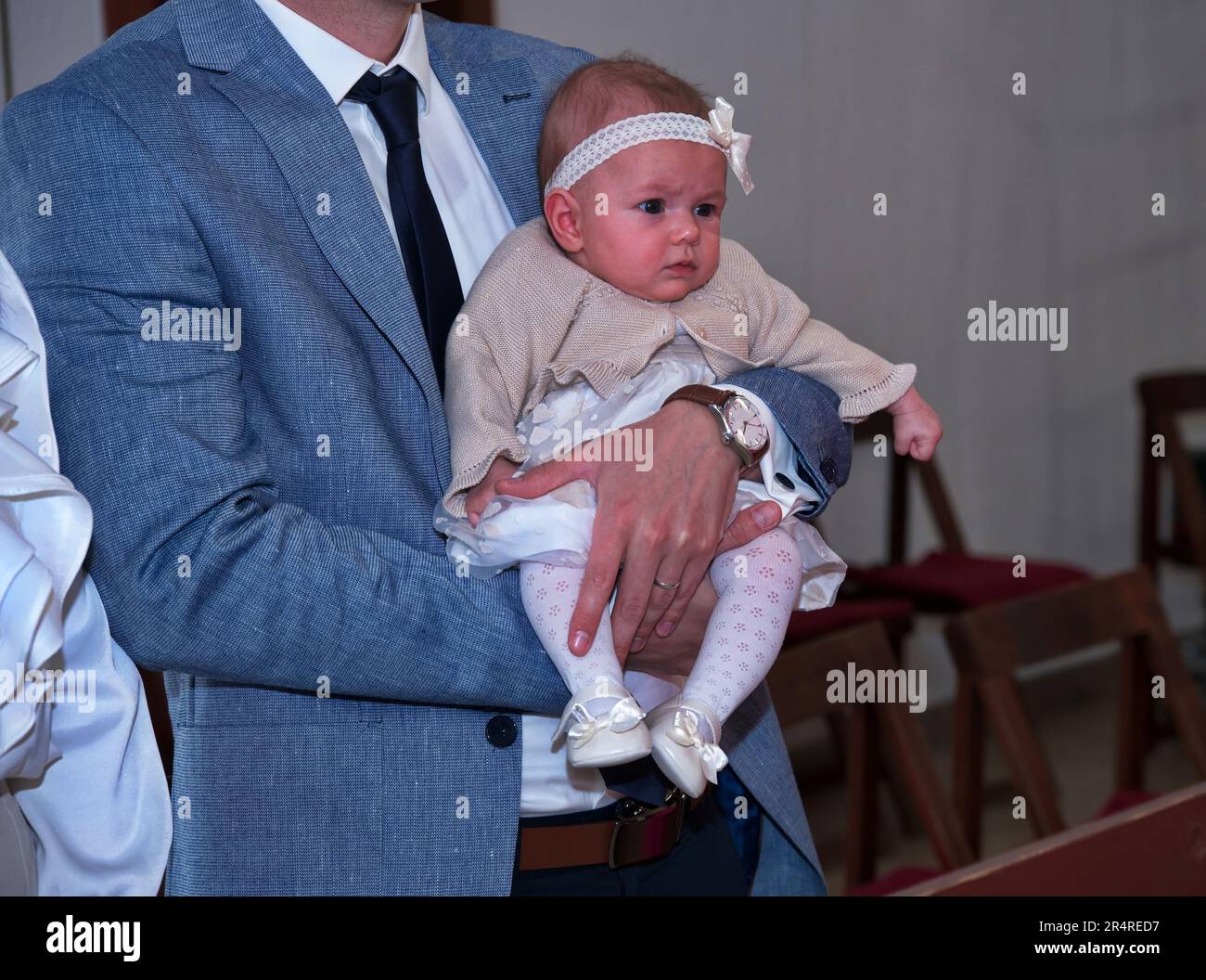 Midsection of father holding his baby girl in a church ready for ...