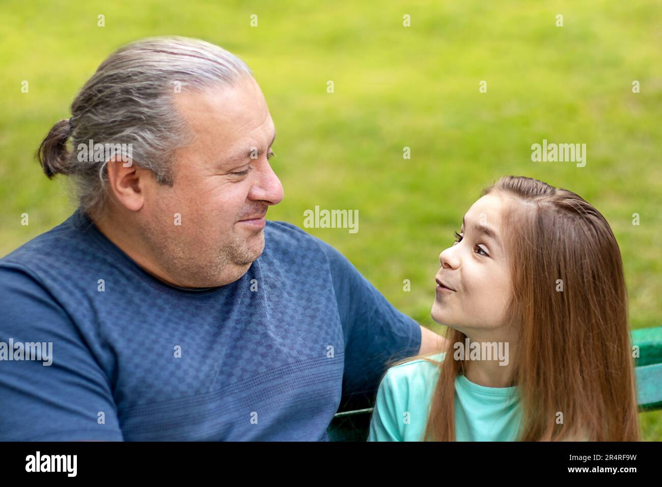 Father and daughter communicate, talk, in the park. Fatherhood ...
