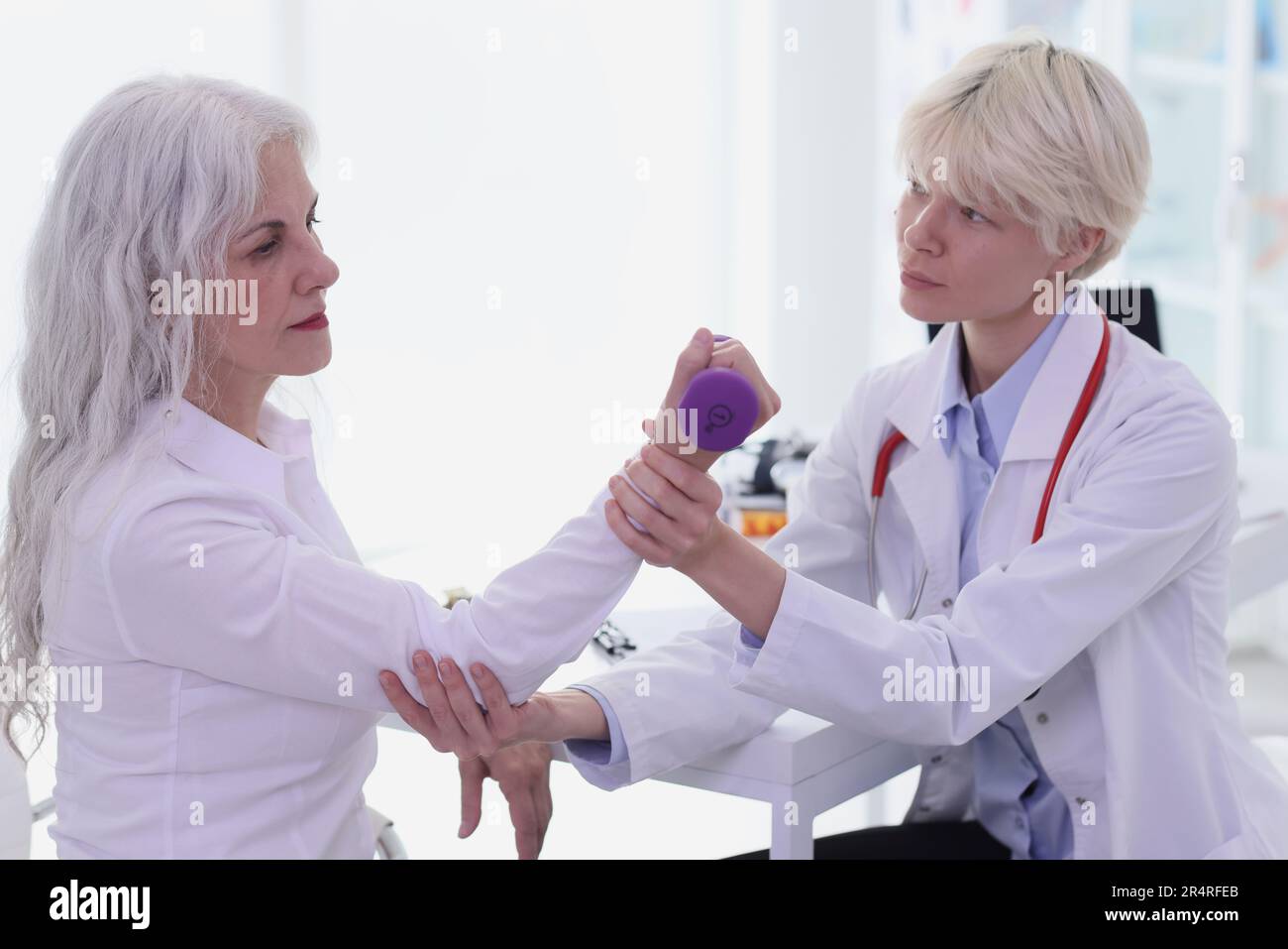 Doctor helps elderly woman hi-res stock photography and images - Alamy