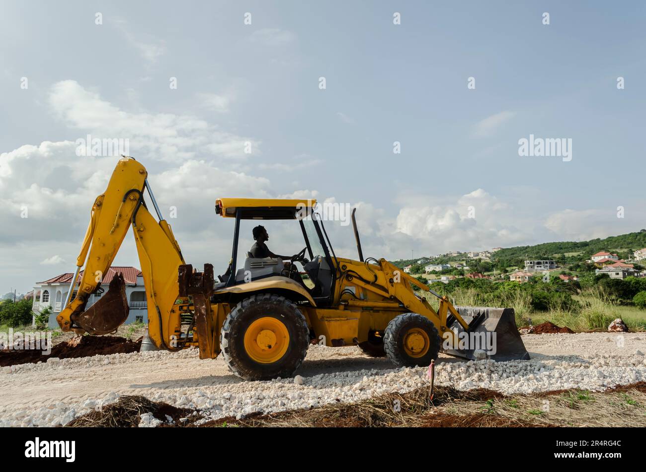 Working On A New Road With A Backhoe Stock Photo - Alamy