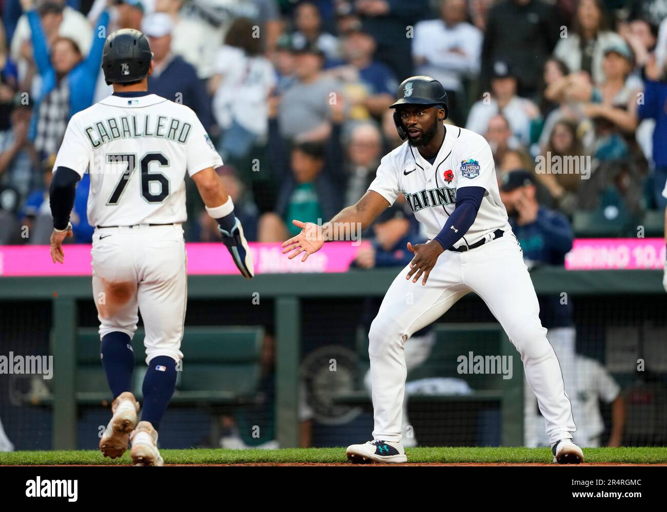 Seattle Mariners' Jose Caballero is greeted by Taylor Trammell as they ...