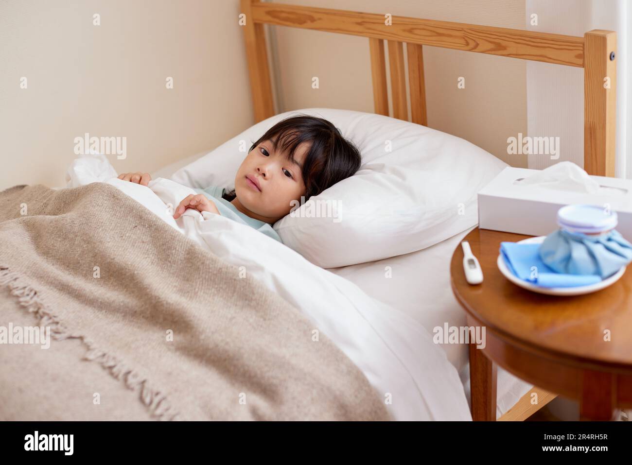 Japanese kid sick in bed Stock Photo - Alamy
