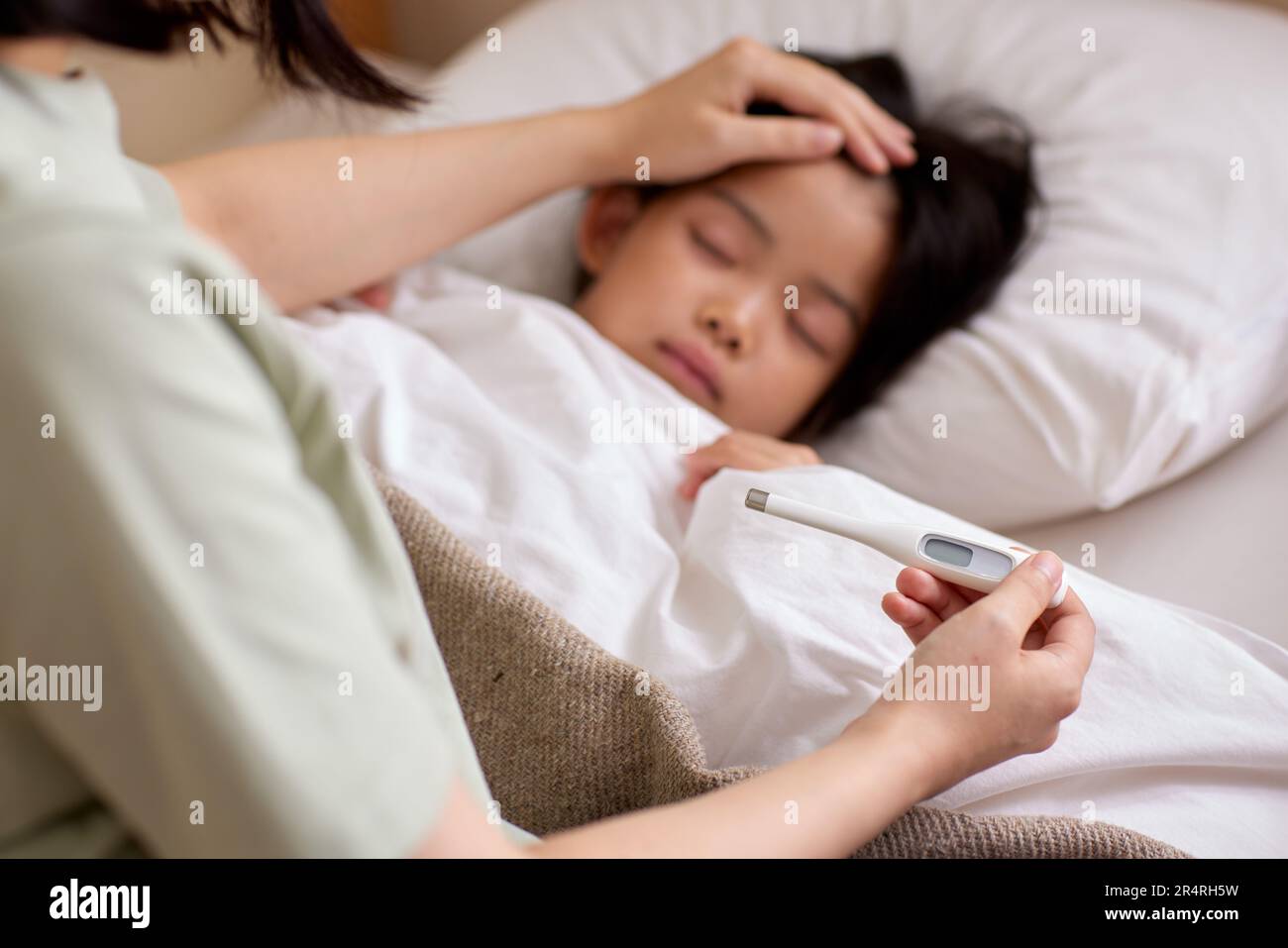 Japanese kid sick in bed Stock Photo - Alamy